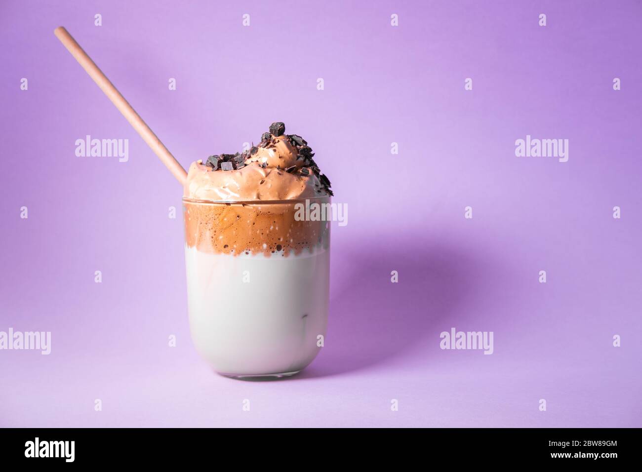 Dalgona coffee isolated on pink background with chocolate chips and ...