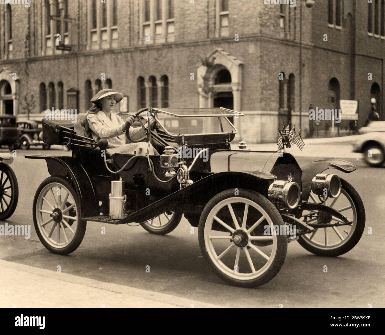 1940s ANONYMOUS WOMAN SITTING DRIVING AN ANTIQUE CAR ABOUT 1910 SMALL ...