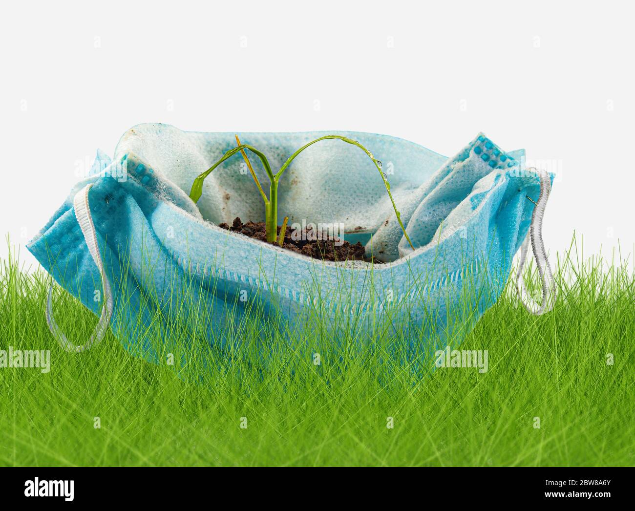green plant growing in protection mask as a pot : the world in ...