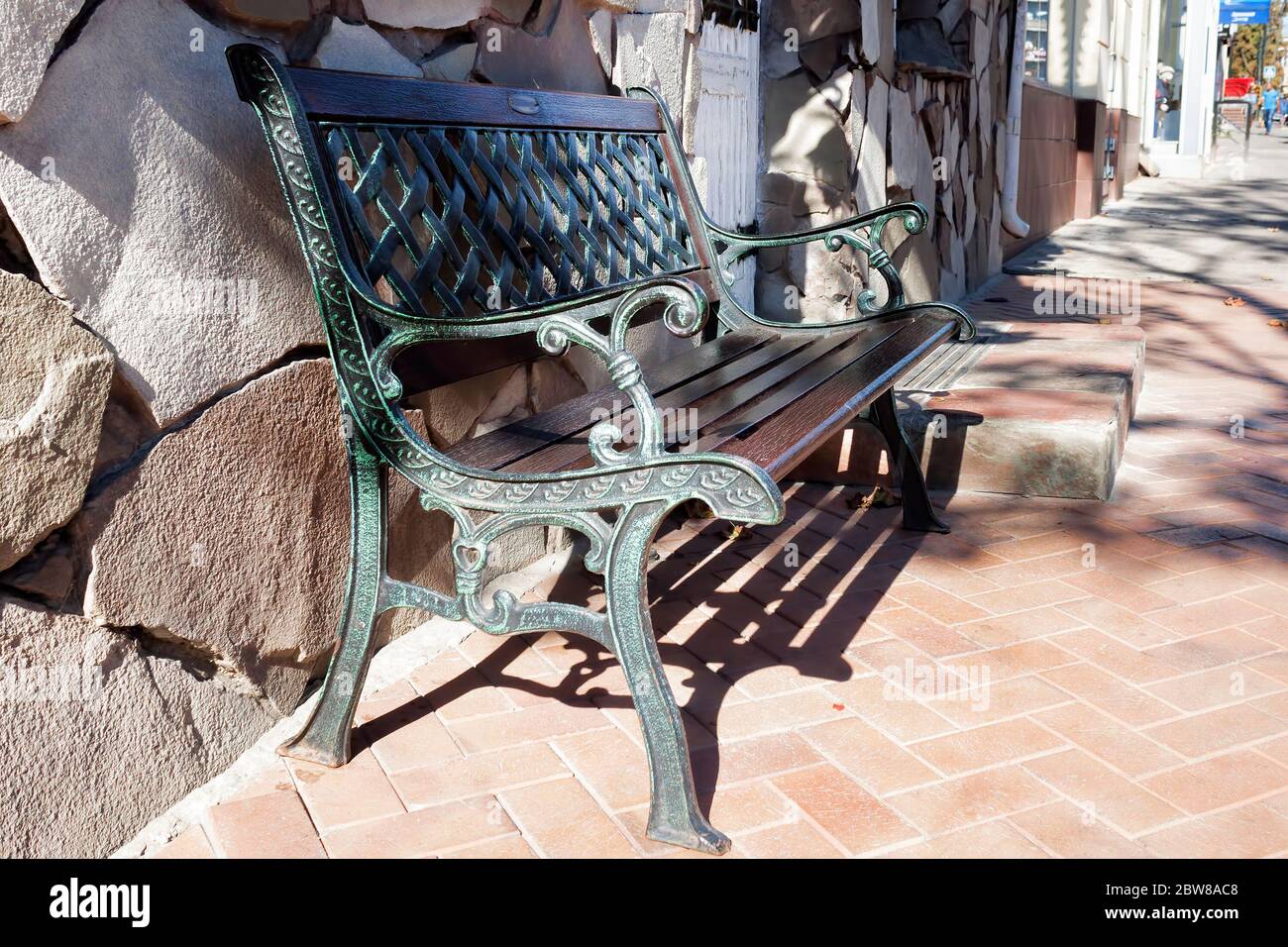 Large decorative bench on the city street near the building wall Stock ...