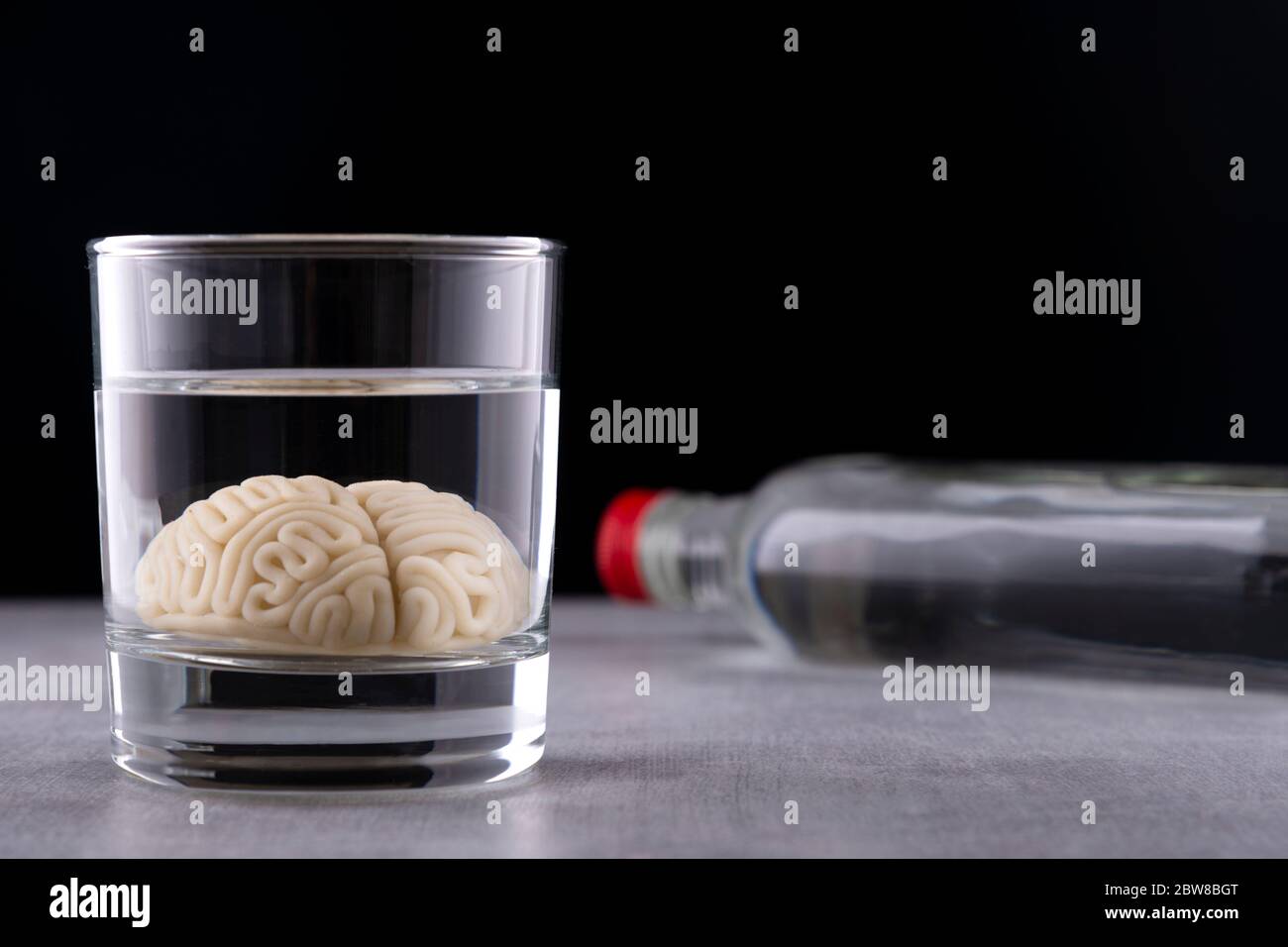 Alcohol addiction concept. Brain drowned in alcohol. Reduce IQ after ...
