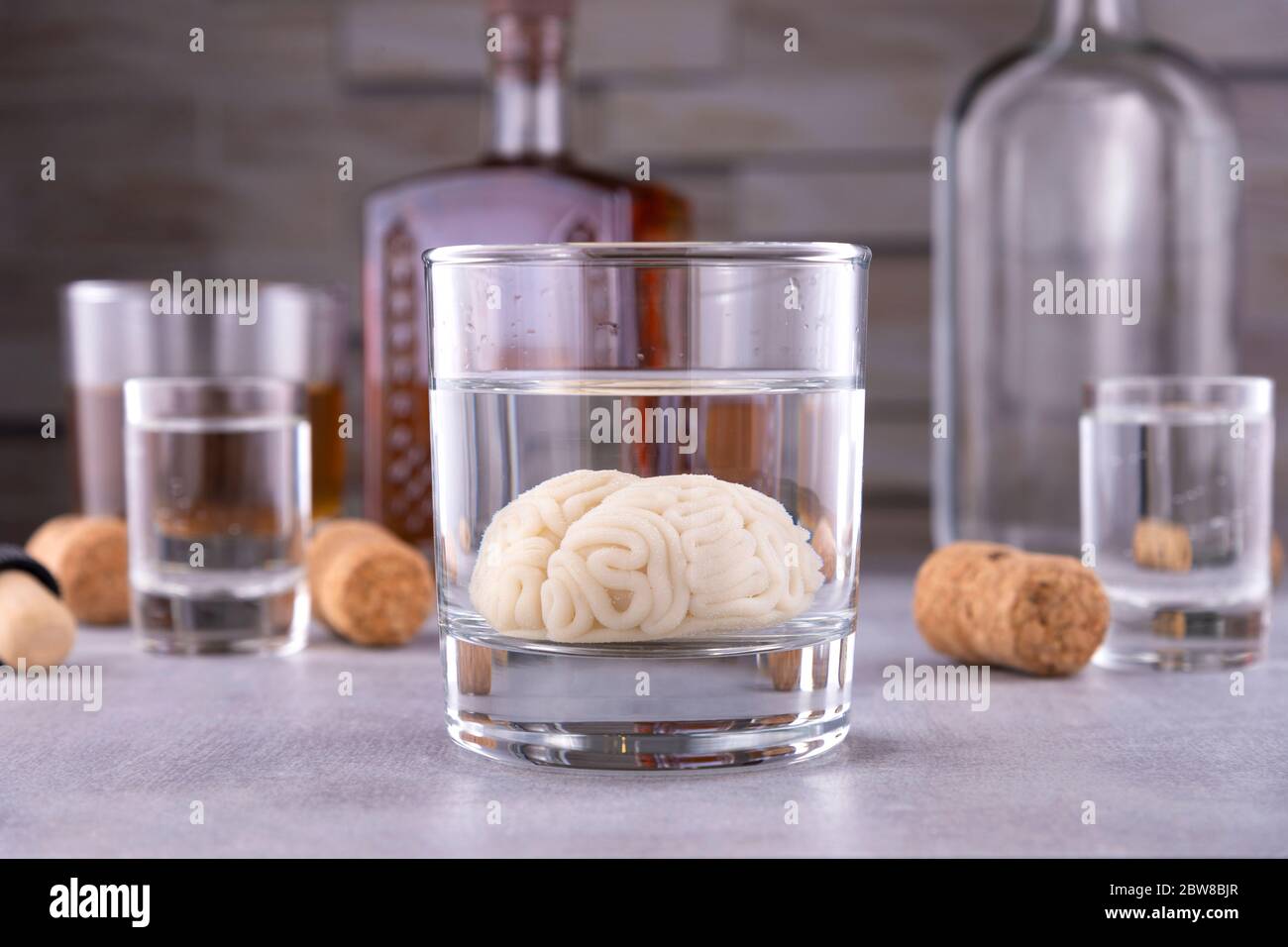 human brain in a glass with an alcoholic drink, against the background ...