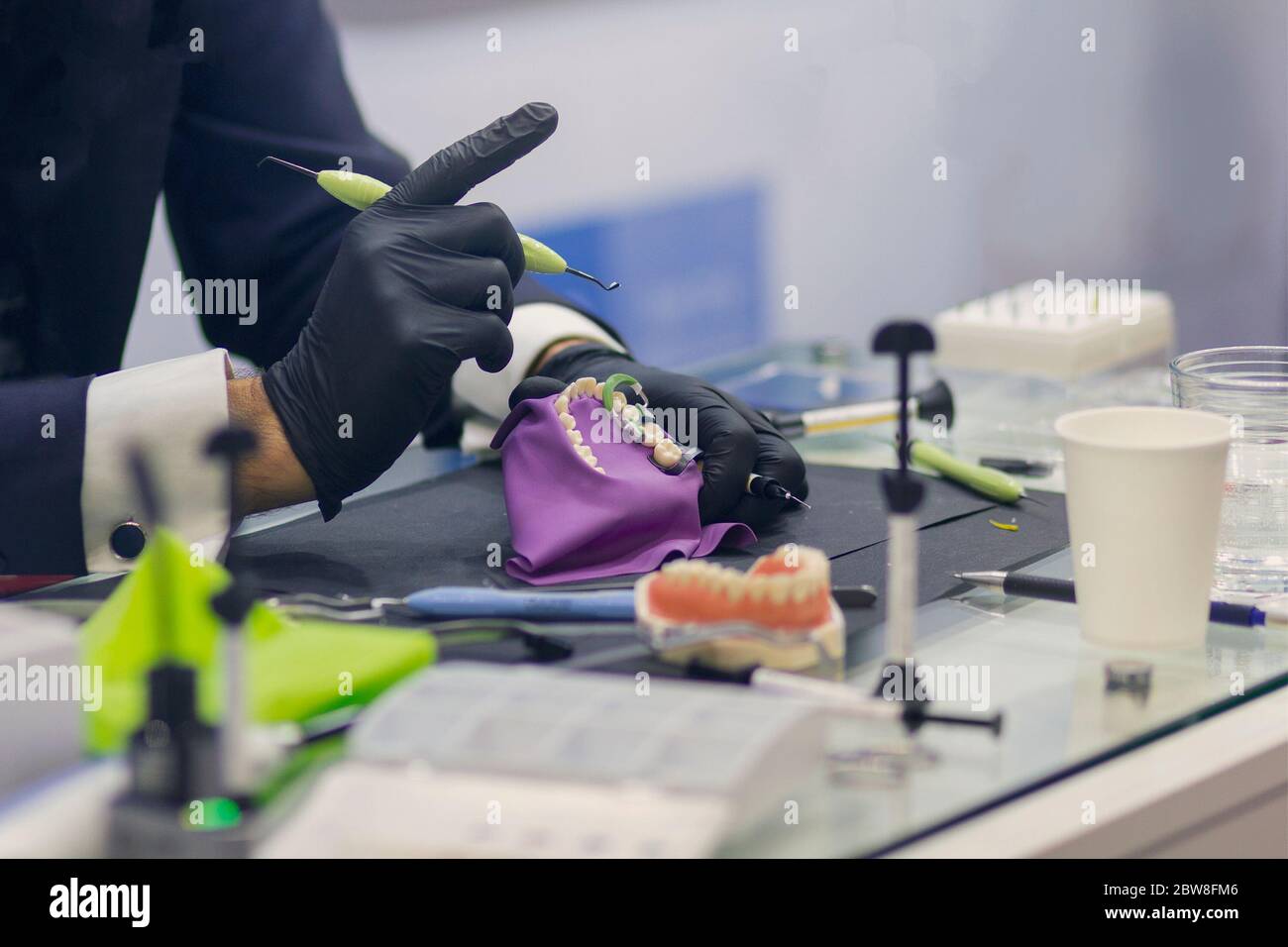 Dental technician or prosthesis worker. Prosthetic dentistry process ...