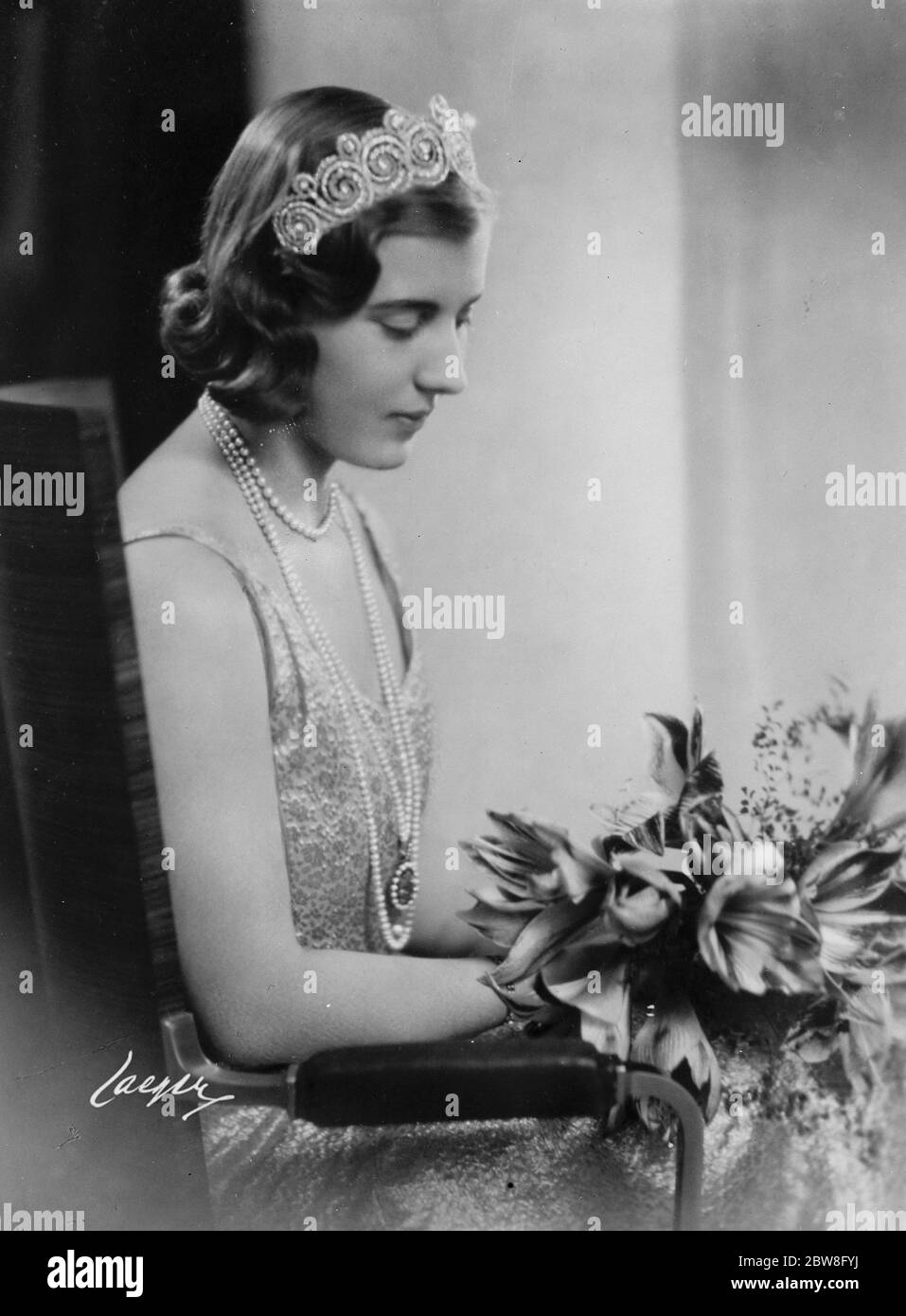 To be godmother to the infant son of the Hon Mrs Loel Guinness ...