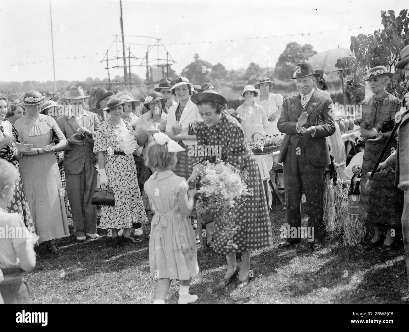 Mrs Bossom wife of Mr Alfred Bossom MP is presented with a bouquet ...