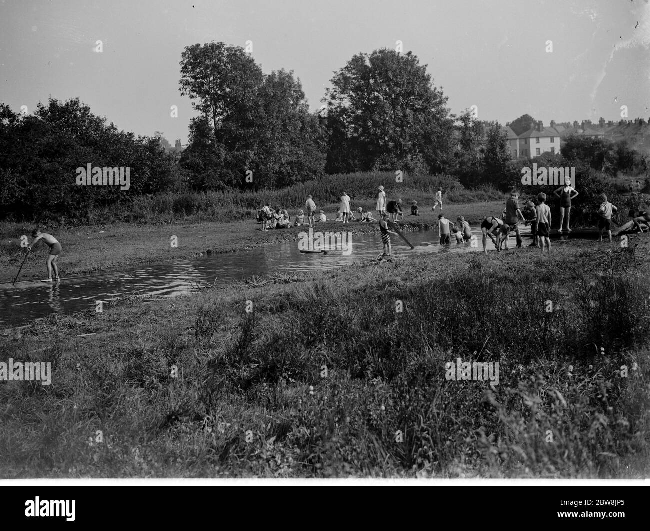 Children playing in the stream . 1935 Stock Photo - Alamy