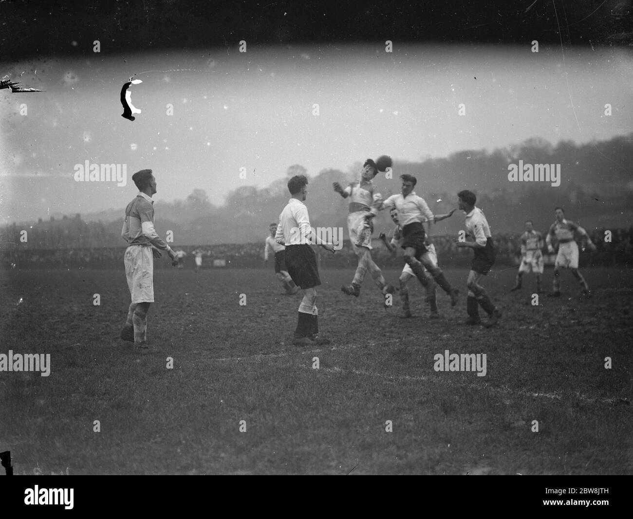 Boys football , two players compete for an aerial ball . 1935 Stock ...