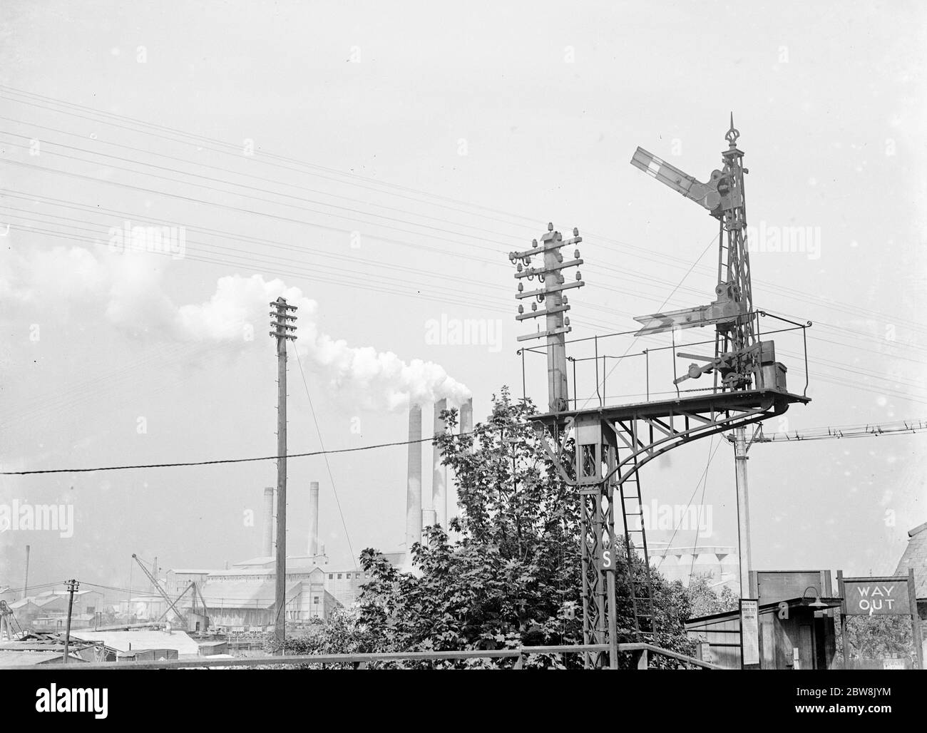Train signal on a gantry with a telegraph pole in the background 1935 ...