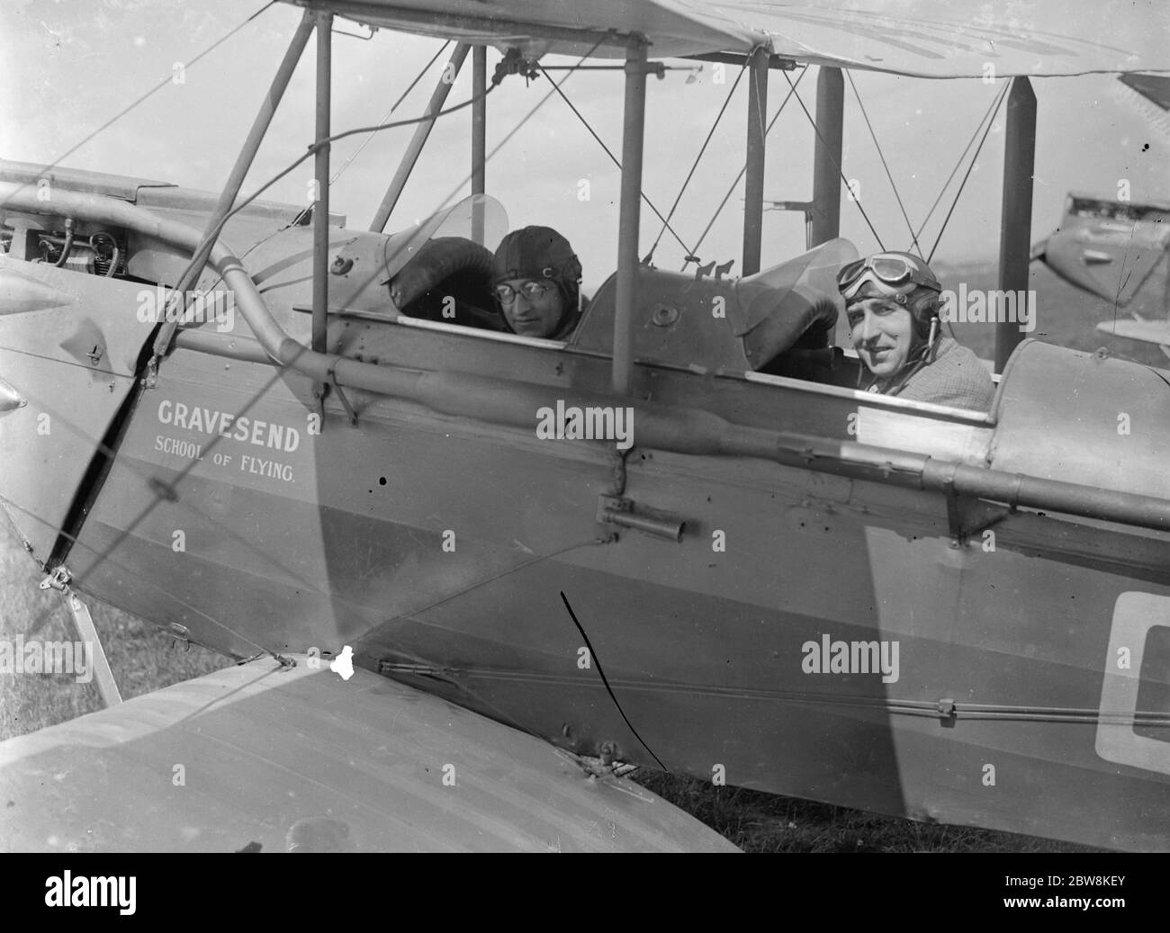 Rupert MItchell and B Drew sit in tandem in their bi - plane just ...