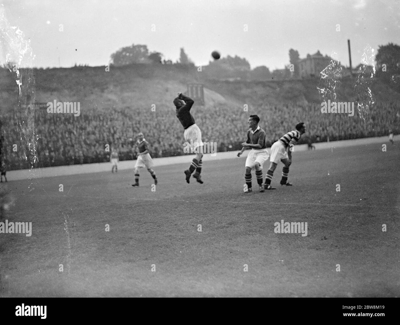 Football match . The goalie struggles to save the ball . 1935 Stock ...