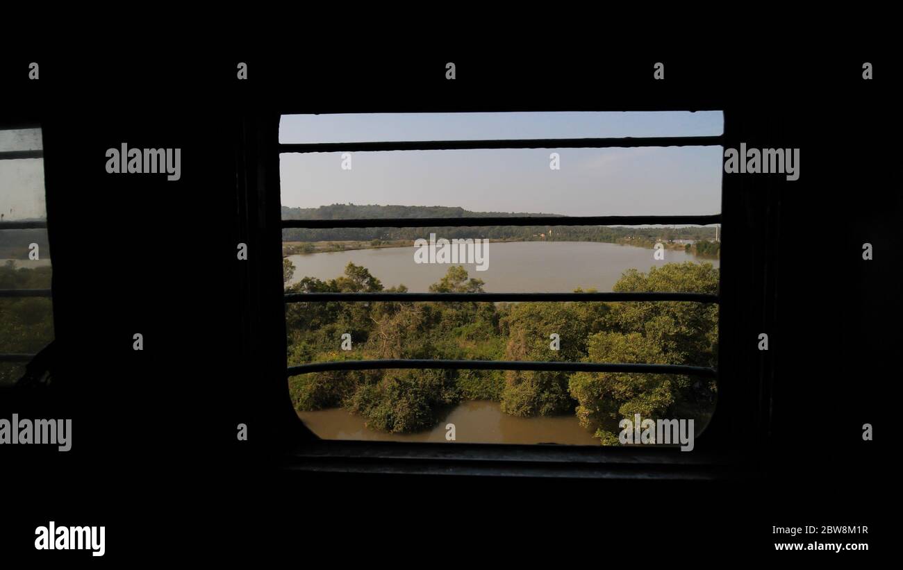 Windows with bars of an indian train Stock Photo - Alamy