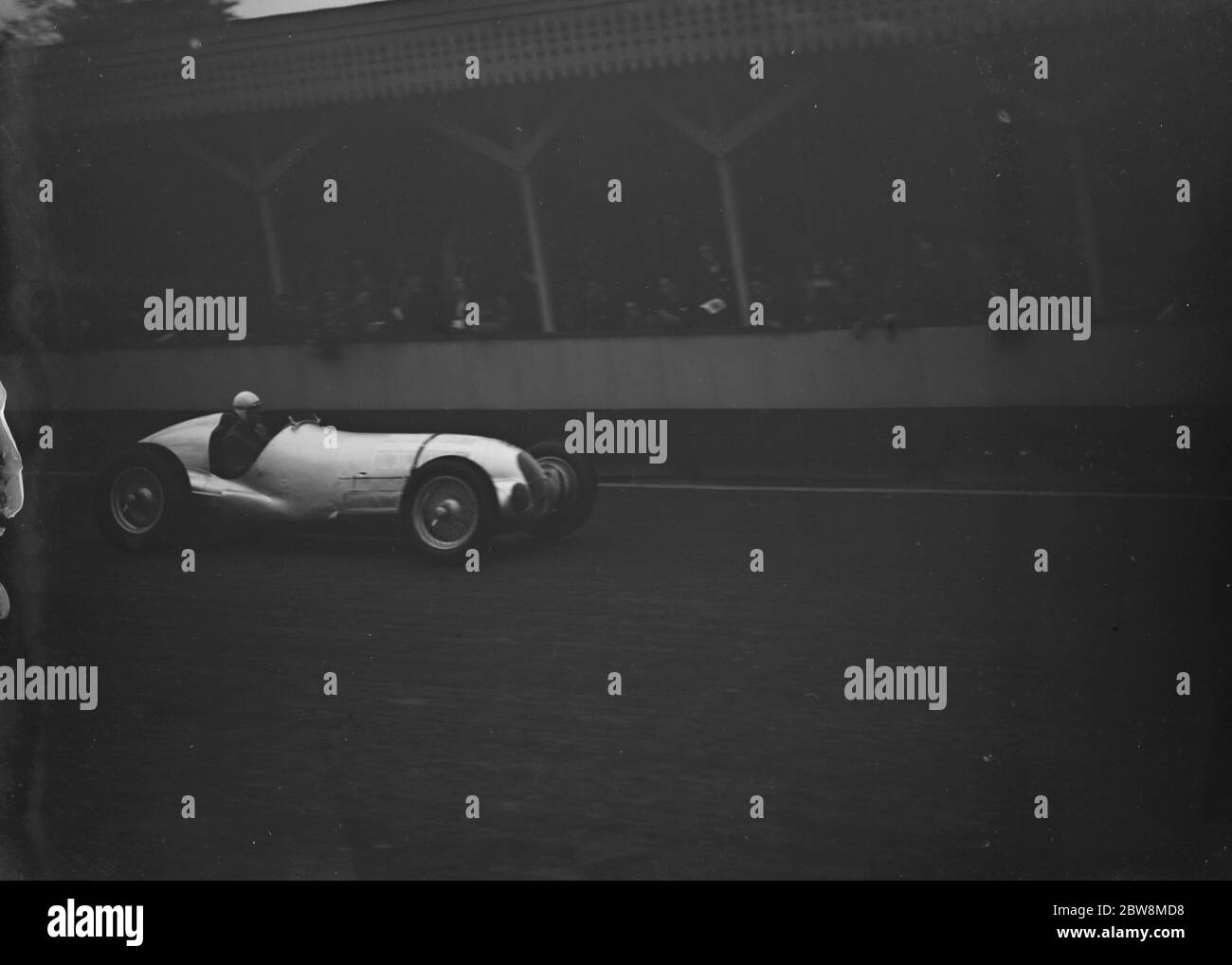 Dick Seaman driving at speed in his Mercedes Benz racing car , the ...