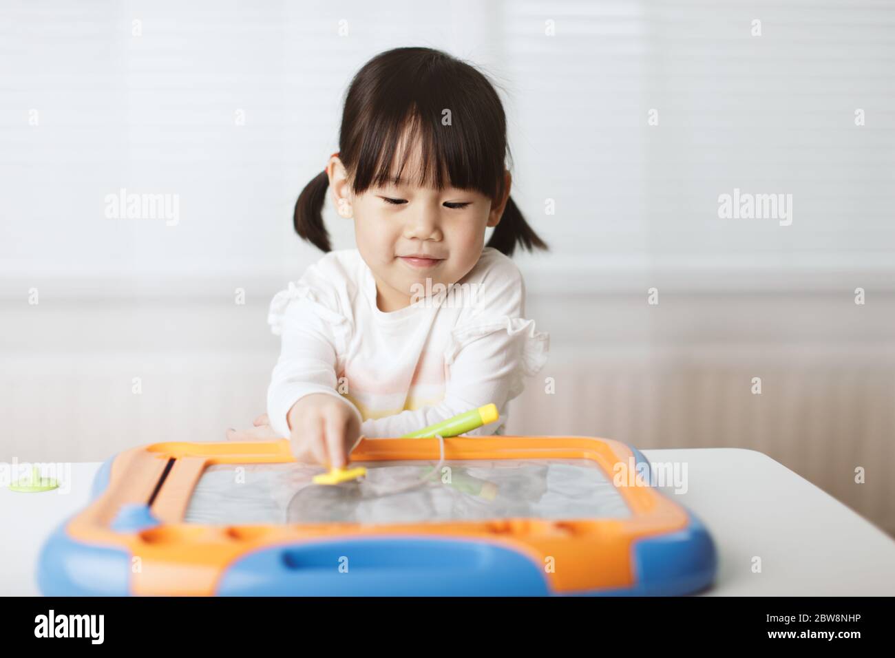 toddler girl learn drawing at home against white background Stock Photo ...