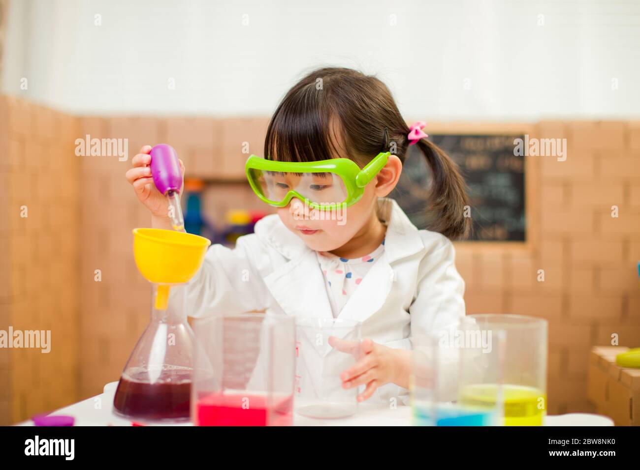 toddler girl pretend play scientist role for homeschooling Stock Photo ...