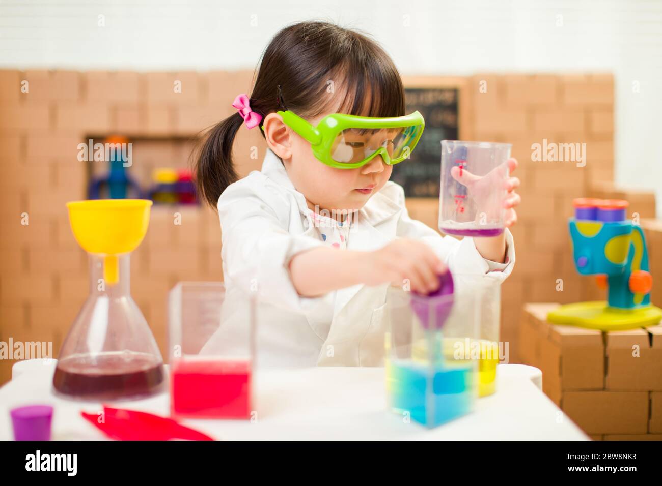 toddler girl pretend play scientist role for homeschooling Stock Photo ...