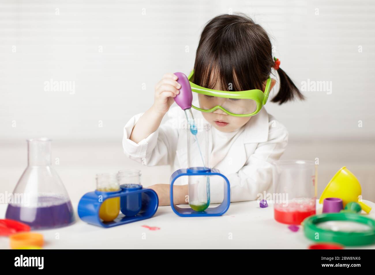 toddler girl pretend play scientist role for homeschooling Stock Photo ...