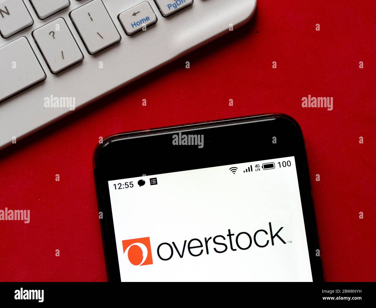 In this photo illustration an Overstock logo seen displayed on a ...