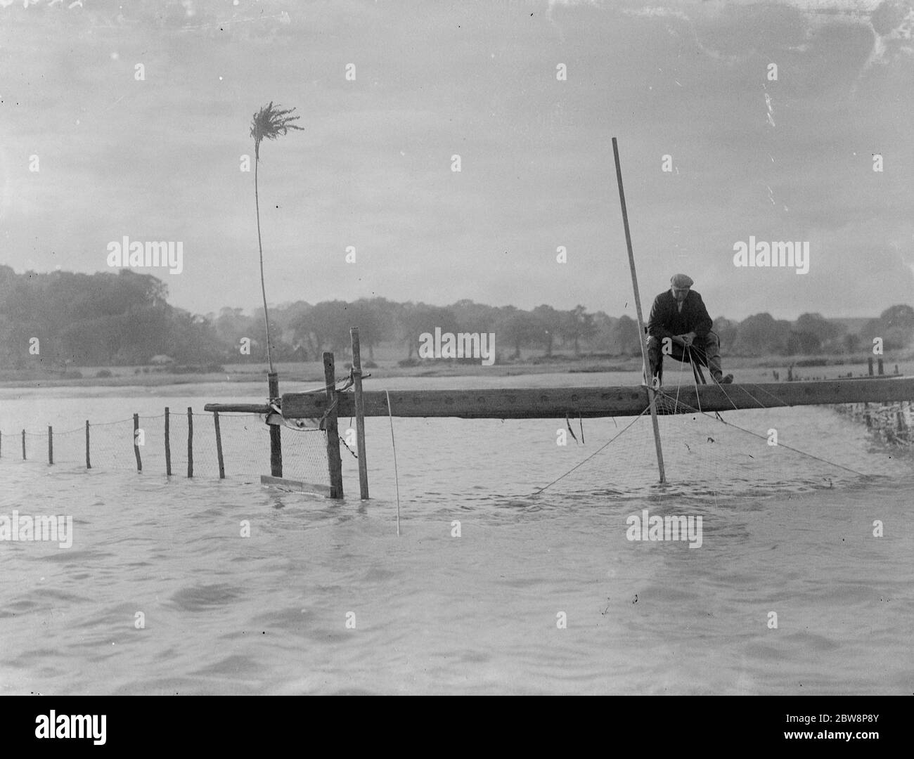 Fishing off jetty Black and White Stock Photos & Images - Alamy