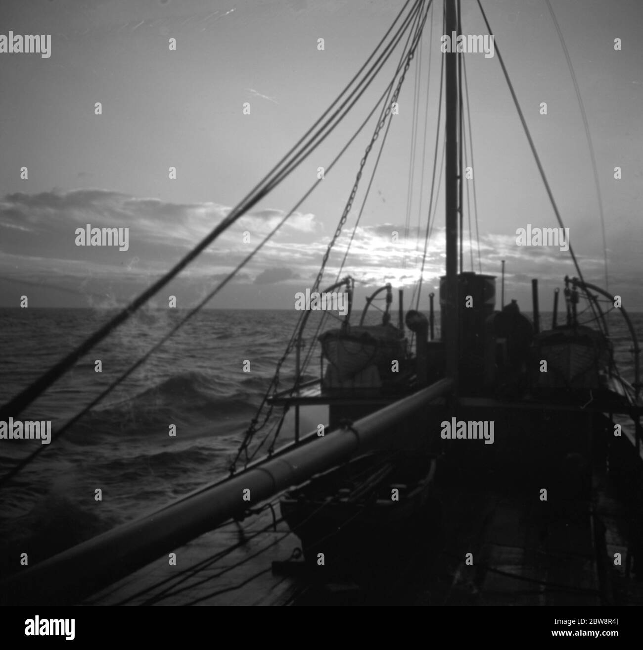 Ship sailing out into the sunset . 1936 Stock Photo - Alamy