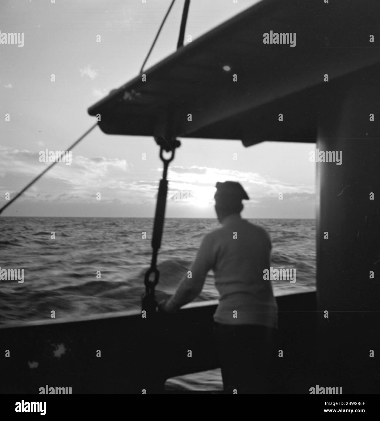 Crewman aboard ship , looking to the horizon . 1936 Stock Photo - Alamy