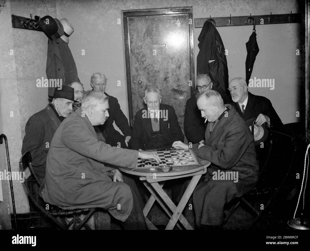 Men playing checkers board game Black and White Stock Photos & Images ...