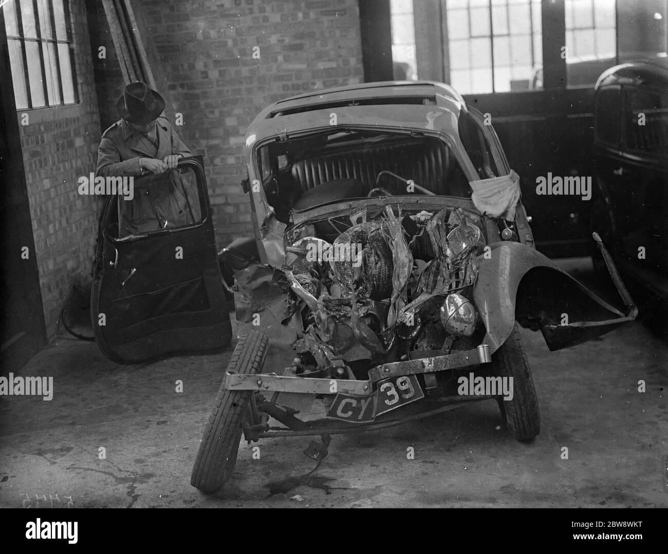 The wrecked car left behind by a crash on Sidcup by pass , Kent . 1937 ...