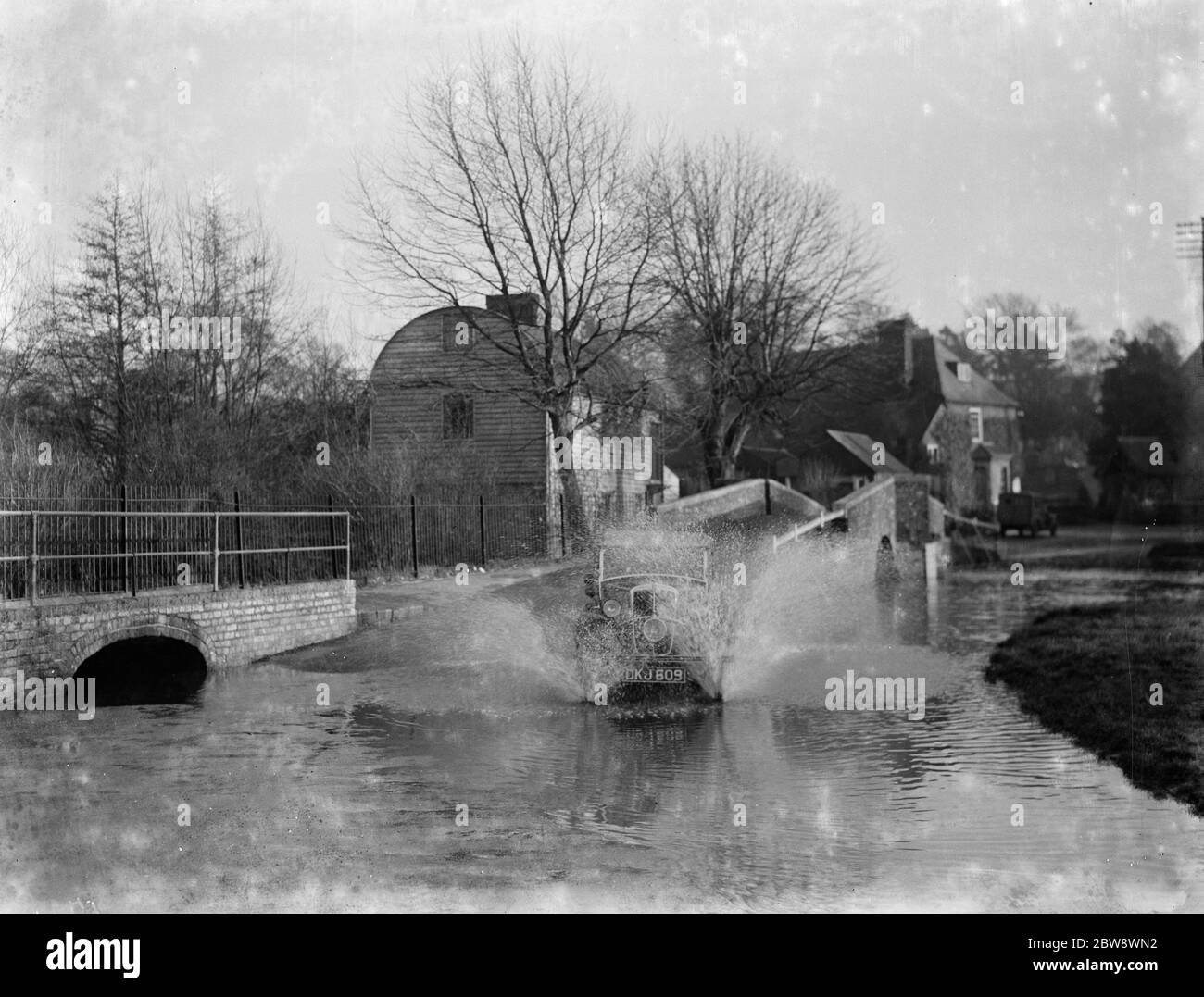 Eynsford Bridge flooded . A car ploughs through the water . 1937 Stock ...