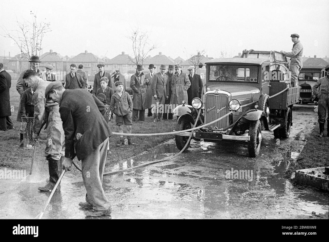 Pattisson demonstrations of an ARP Lorry . Men are hosing down the road ...