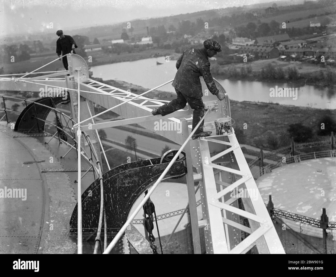 Workmen painting the girders around a gasometer . 1936 Stock Photo - Alamy