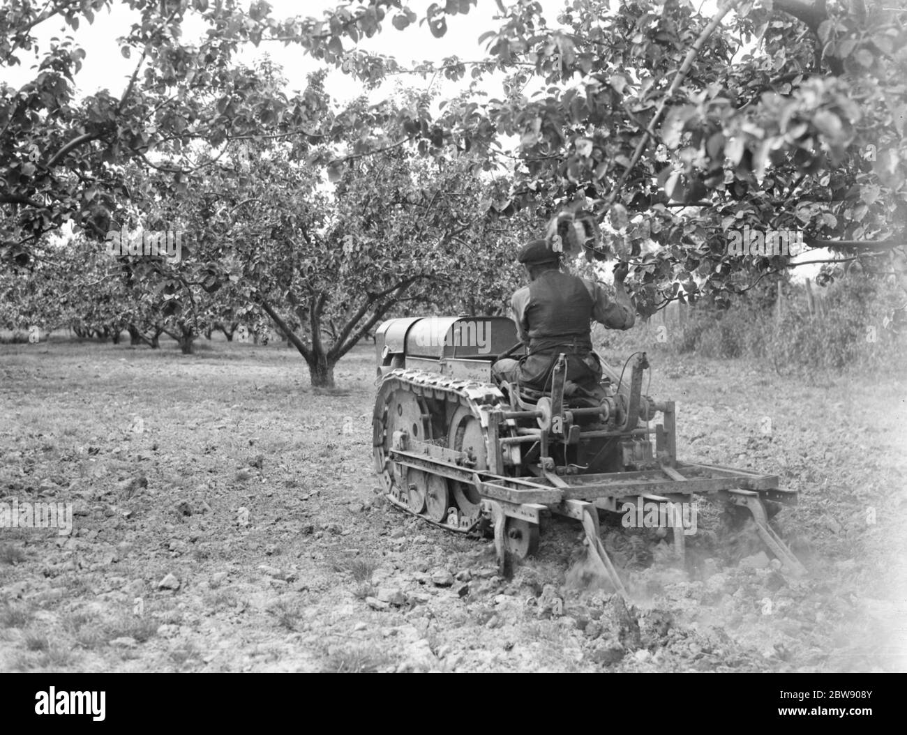 A tractor drawing a harrow on a field at the East Malling Research ...