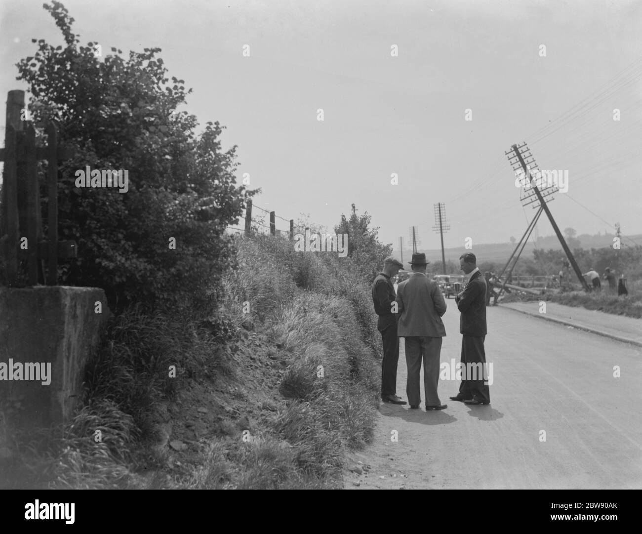 A ladder is positioned to support a damaged pylon following a lorry ...