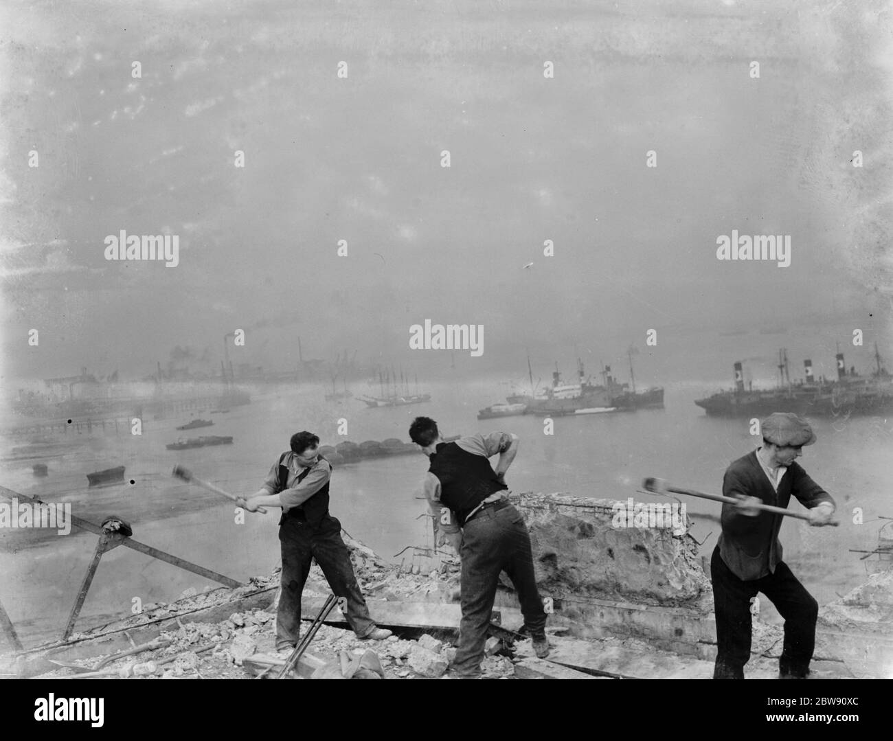 Men working on the redevelopment of the Erith riverside in London ...