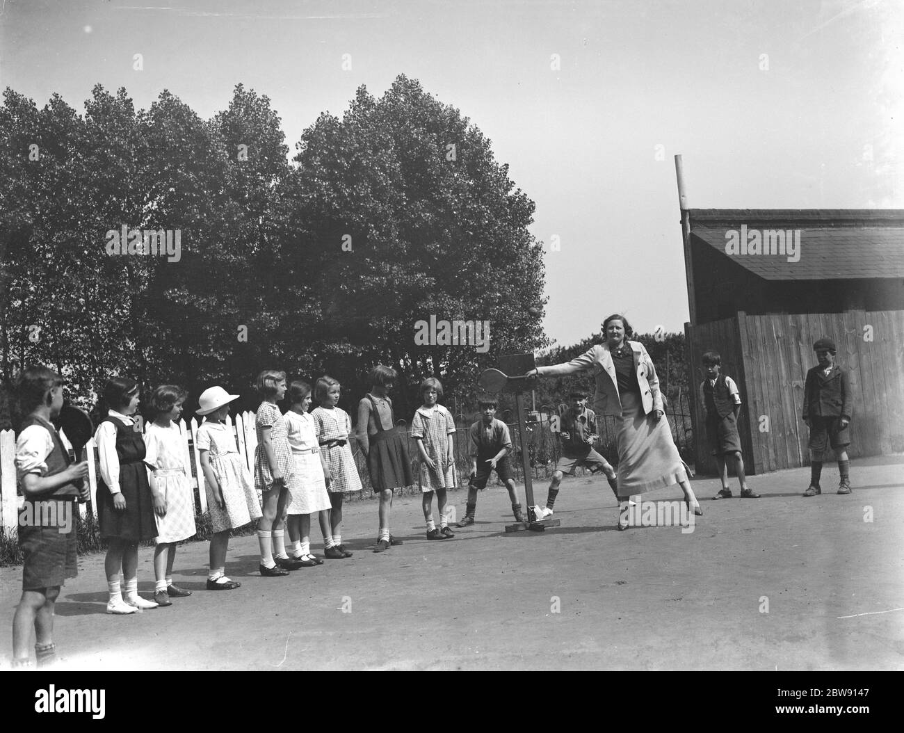 A woman playing stoolball with children in Hartley , Kent . 1937 Stock ...
