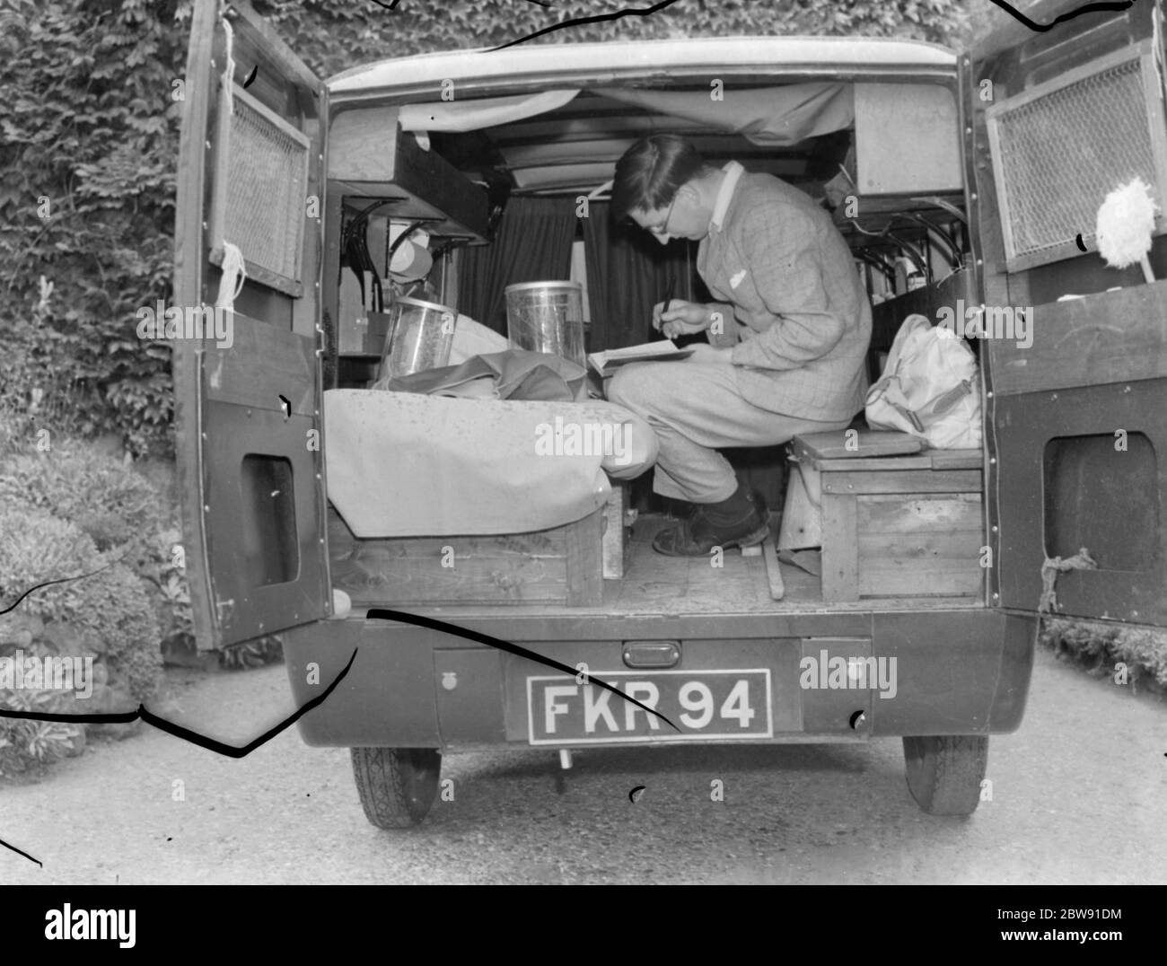 Mr R L G Ford a field entomologist , studying specimens in the back of ...