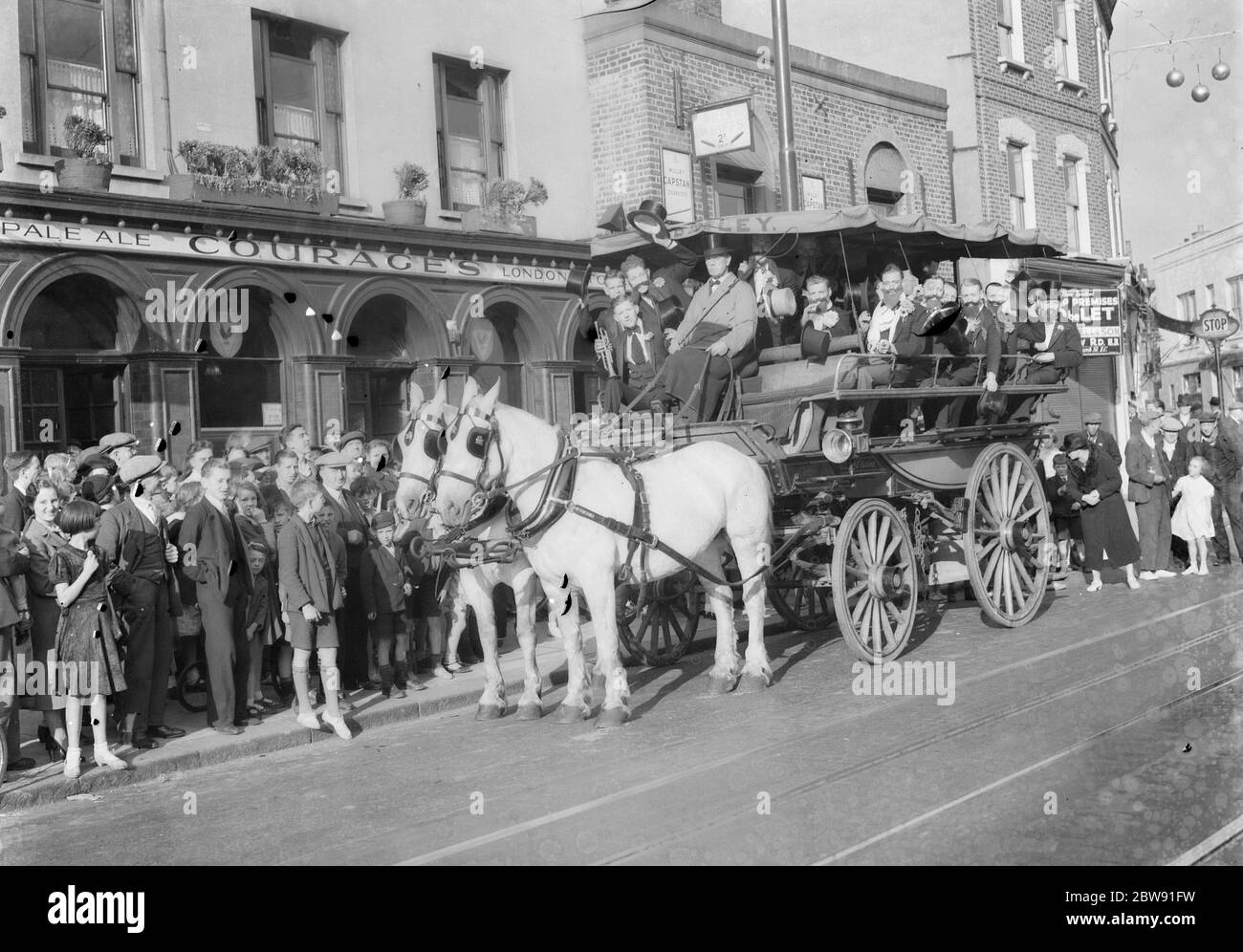 An old stagecoach crammed with passengers rolling down Deptford High ...