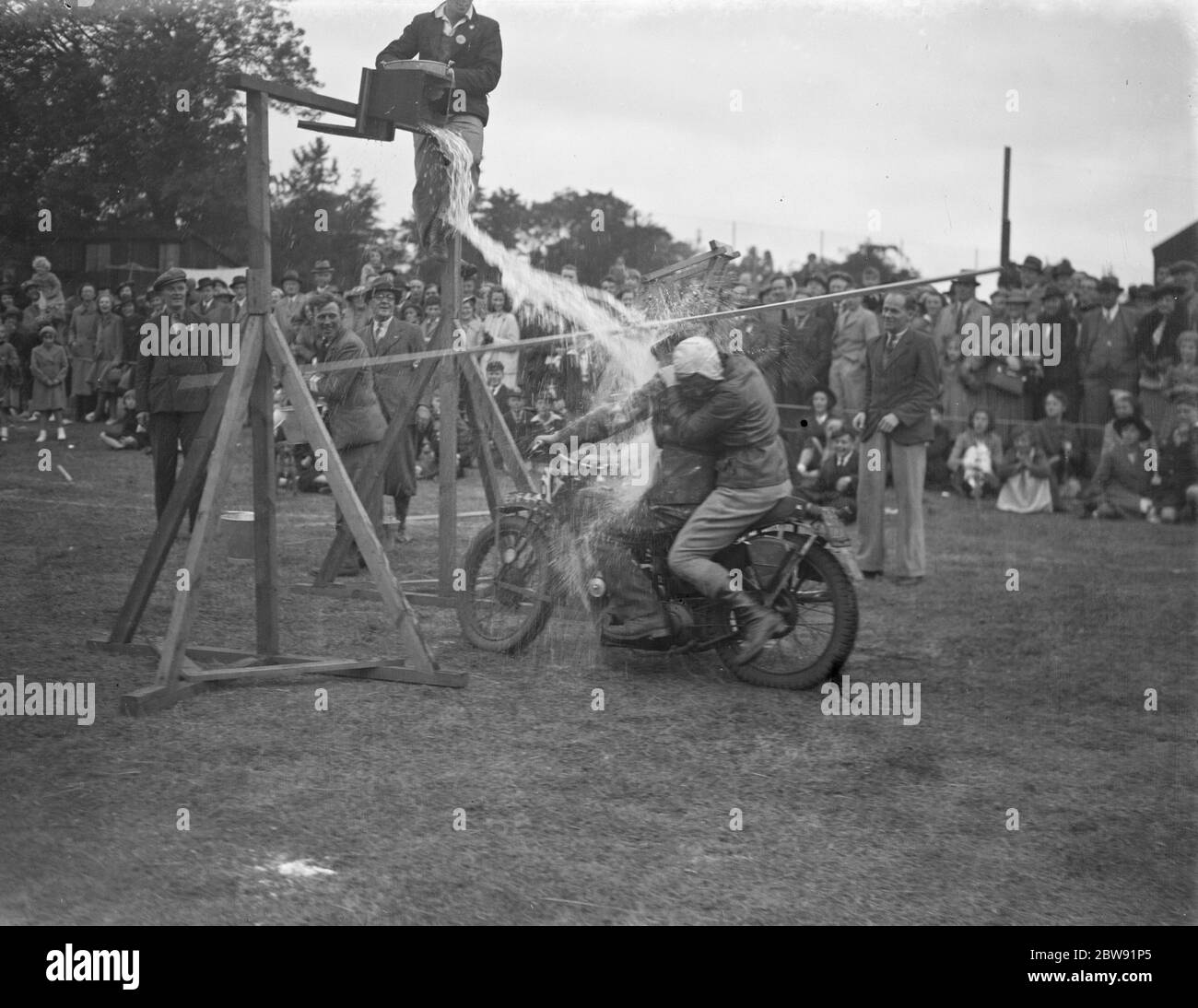 Tilting the bucket at the motorcycle gymkhana . 1939 Stock Photo - Alamy