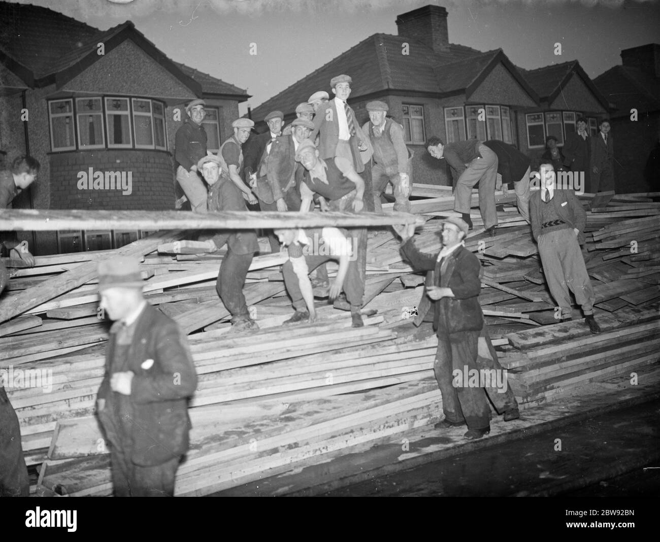 Men rescuing timber from the fire at the timber yard in Welling in Kent ...