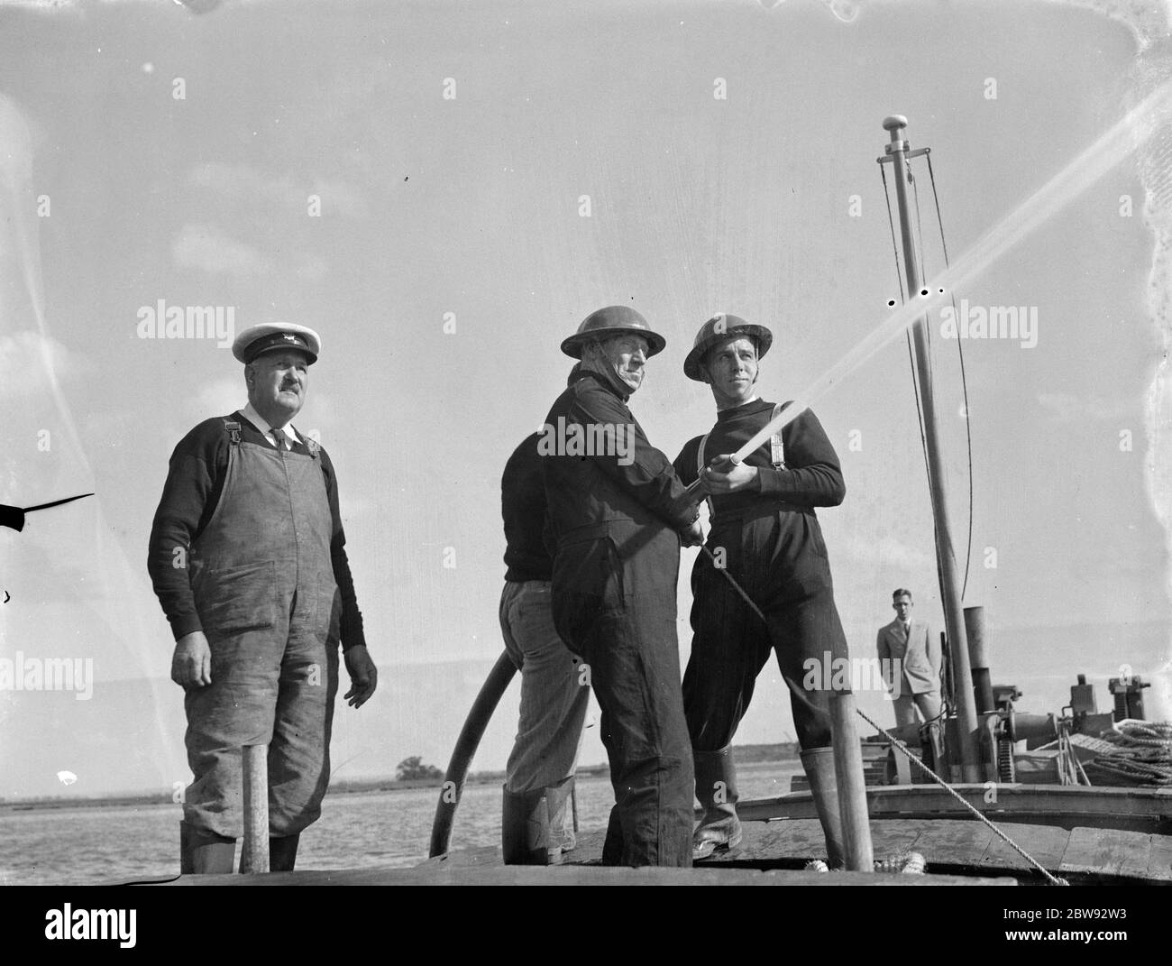 The Erith Auxilliary Fire Service practicing with a hose on board a ...