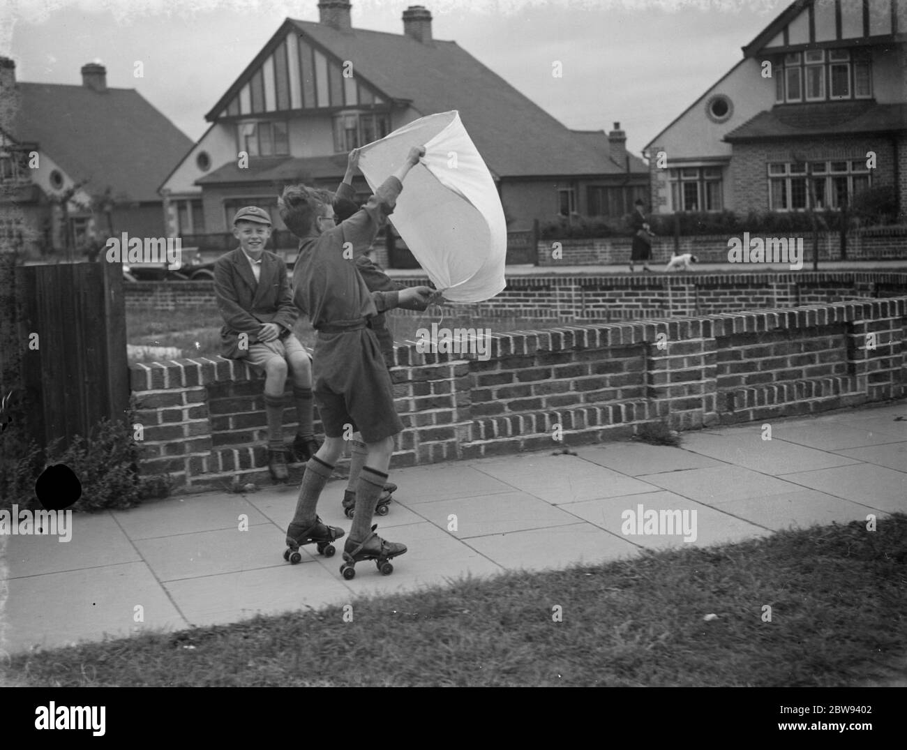 Boys roller skating using a sheet as a windsail . 1938 Stock Photo - Alamy