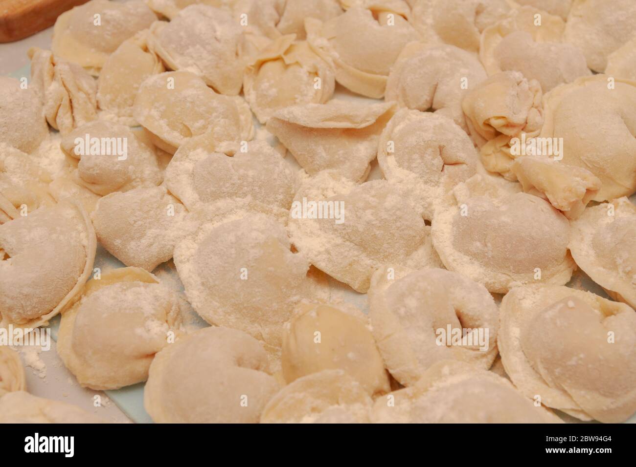 Homemade dumplings are put together on a Board in the kitchen Stock ...