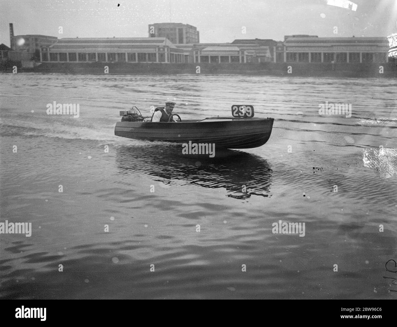 Motorboat racing on the Welsh Harp . Competitors all out throwing up a ...