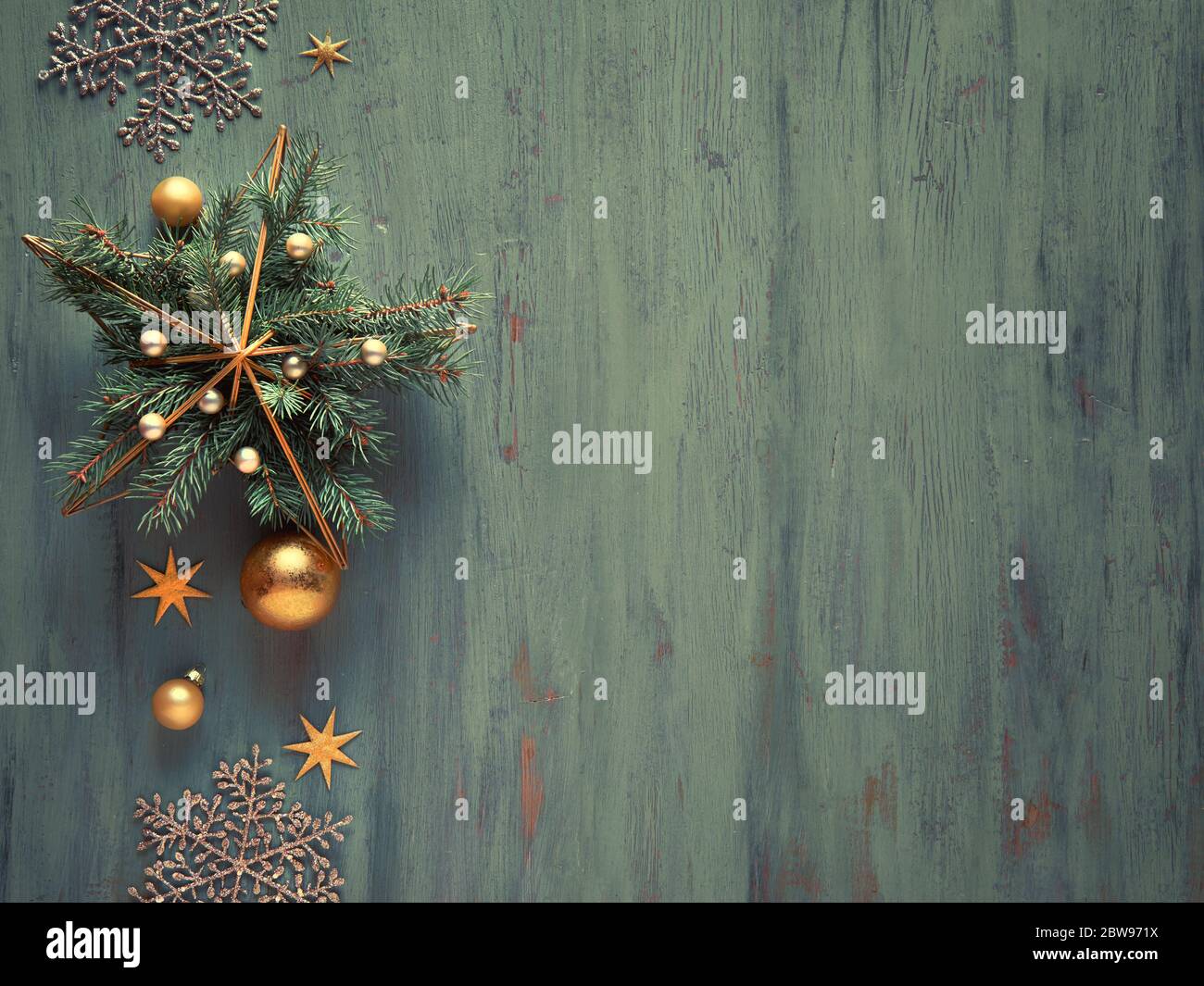 Metal gilded star shape with natural fir twigs and golden baubles ...