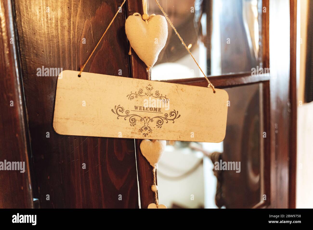 Entrance door decoration. Textile hearts and welcome label with drawn ...