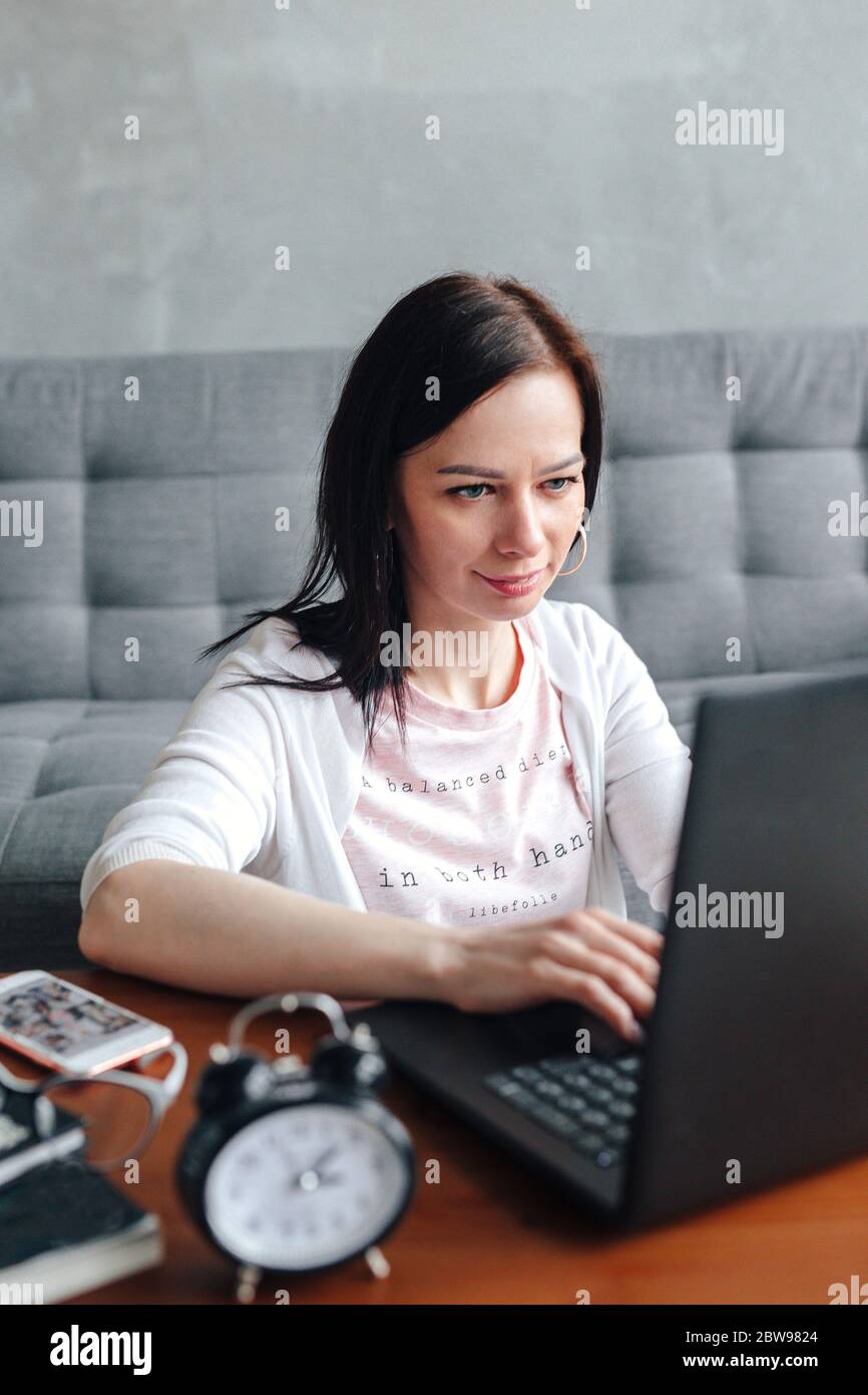 Young woman working at home in the evening Stock Photo - Alamy