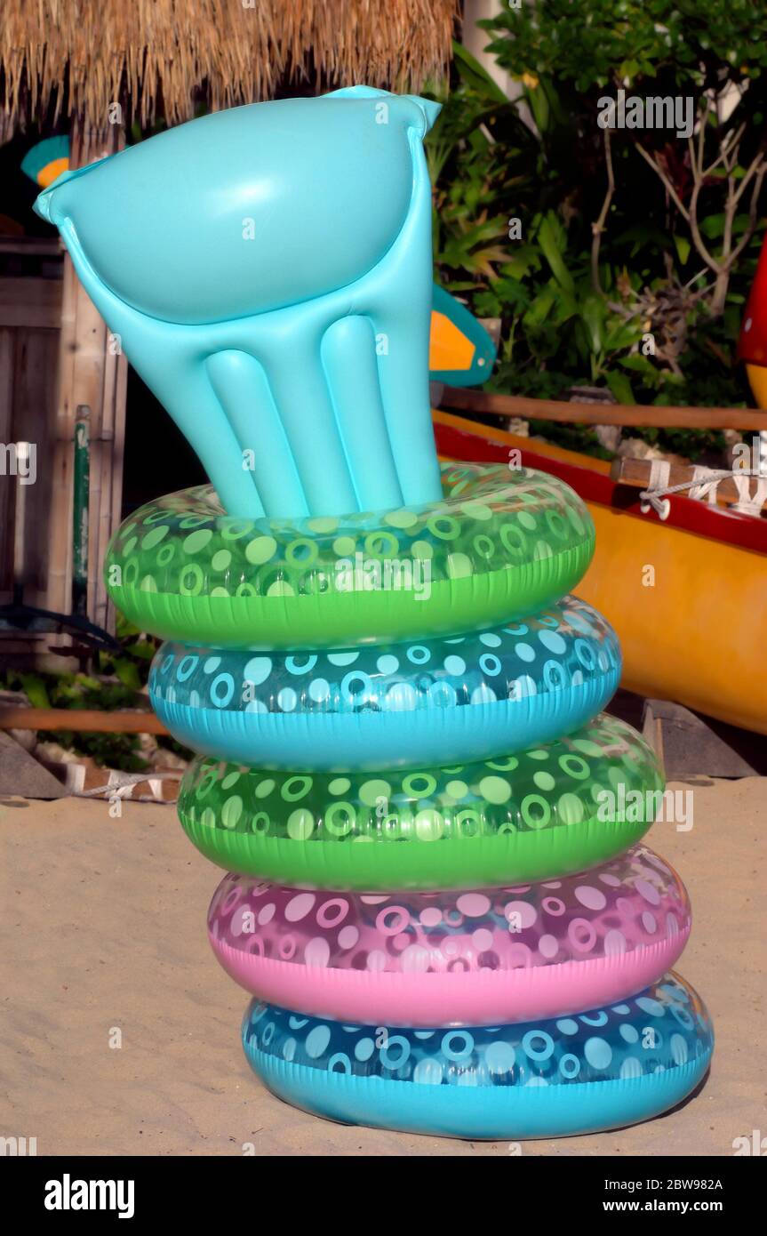 Colorful swimming rings are organized and held in place by sticking an ...