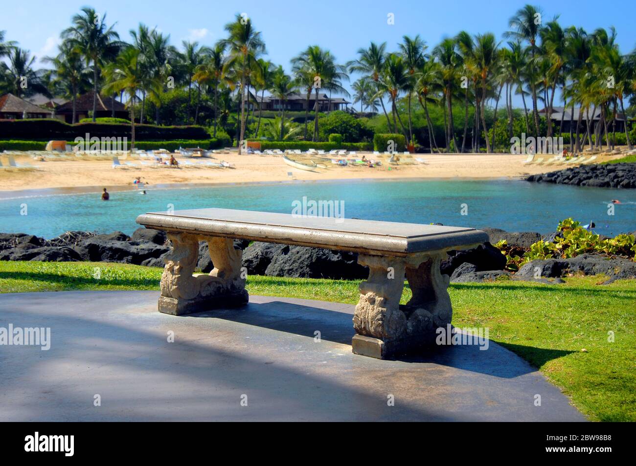 Resort bench overlooks beach and resort activities on the tropical ...