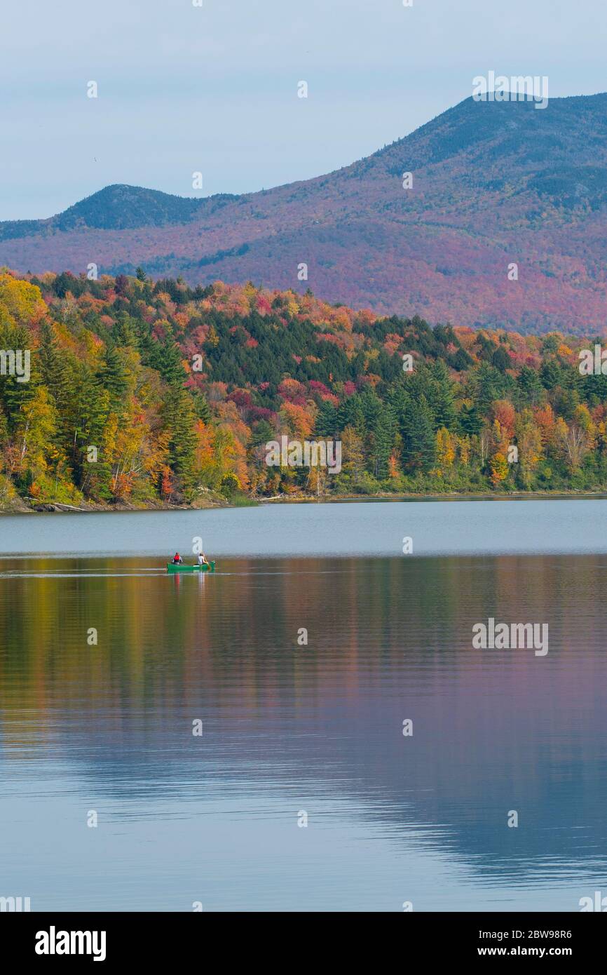 Canoers paddle the water at the Waterbury, VT reservoir during peak ...
