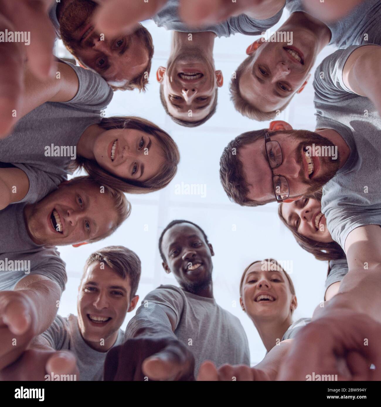 bottom view. a group of successful young people pointing at you Stock ...