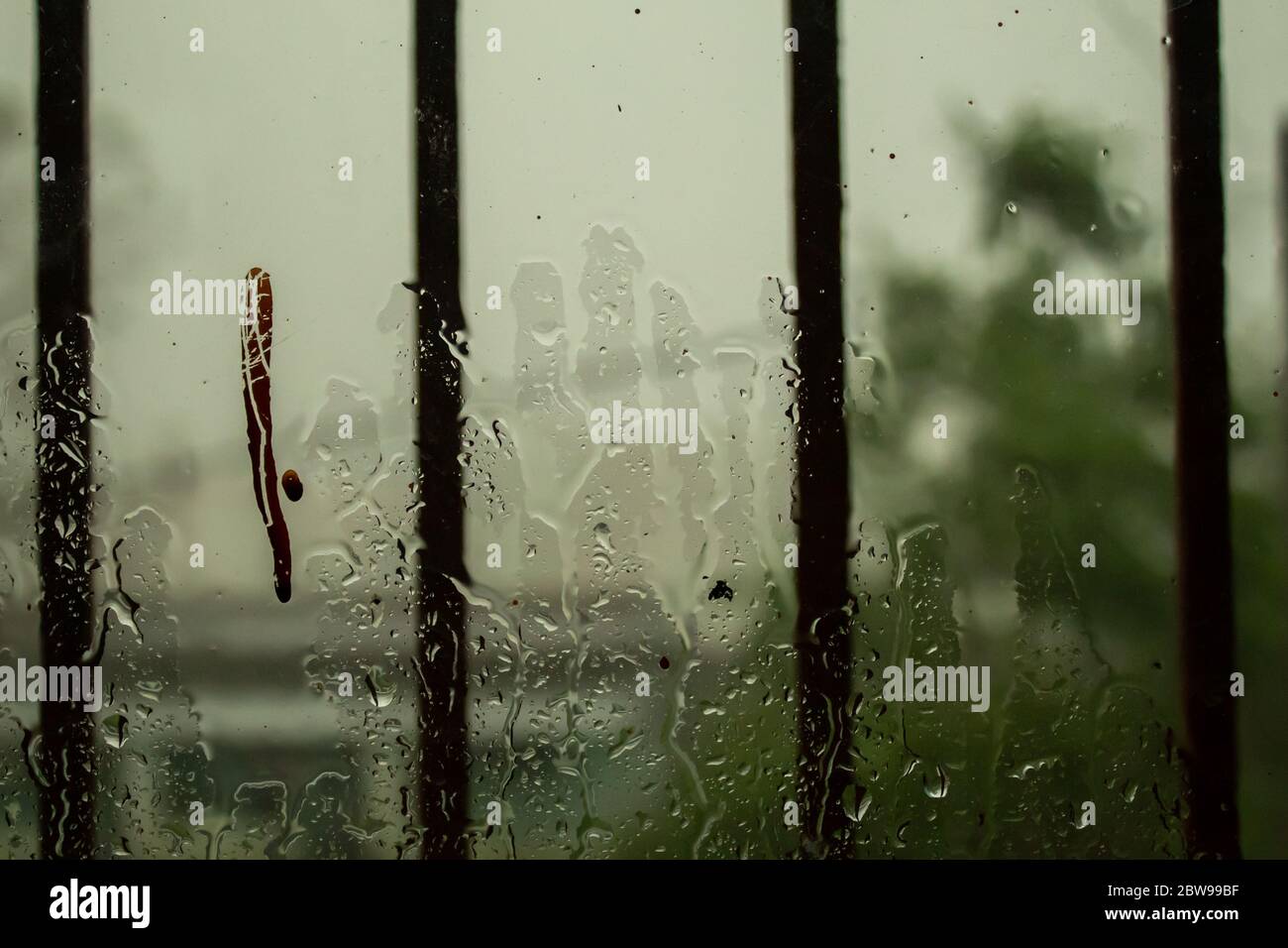 Handprint on window glass during rainy evening Stock Photo - Alamy