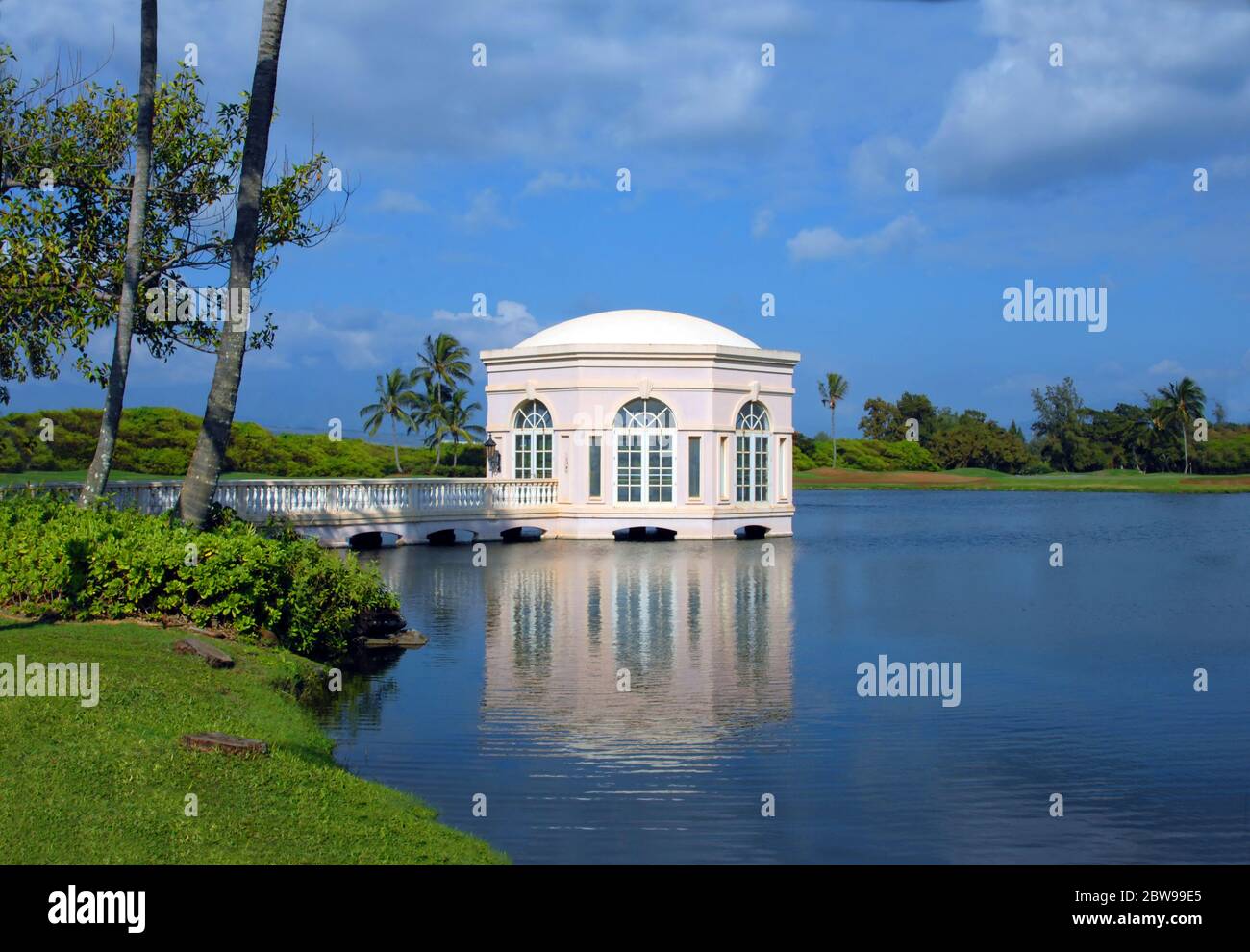 Wedding chapel is reflected in the still waters of a lagoon on the ...